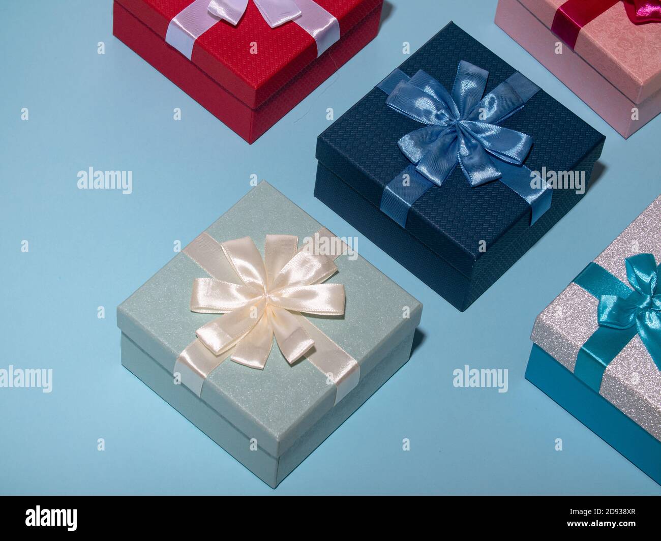 Different colored gift box on pastel blue background. Top view of ...