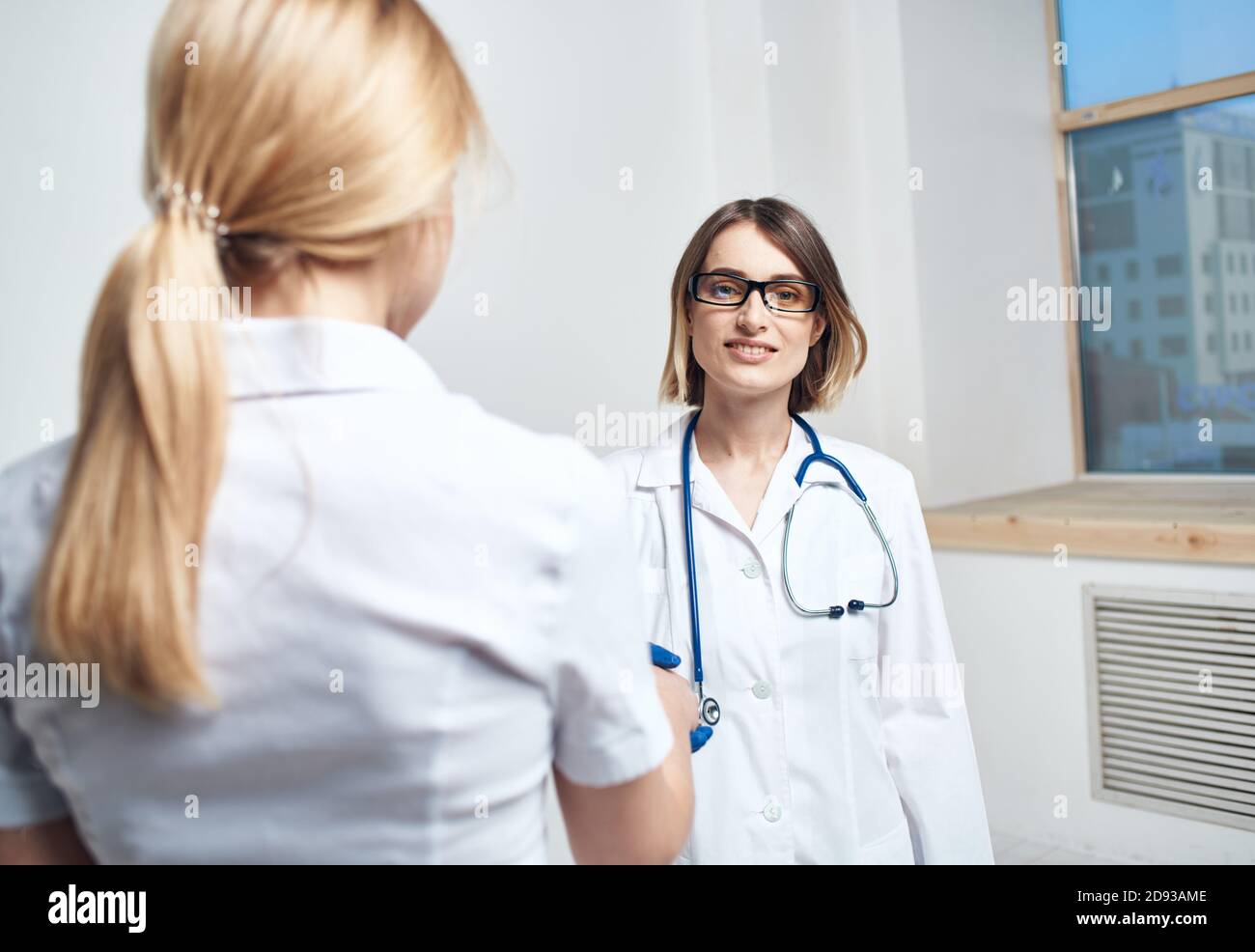 Doctor and patient near window in hospital interior Stock Photo - Alamy