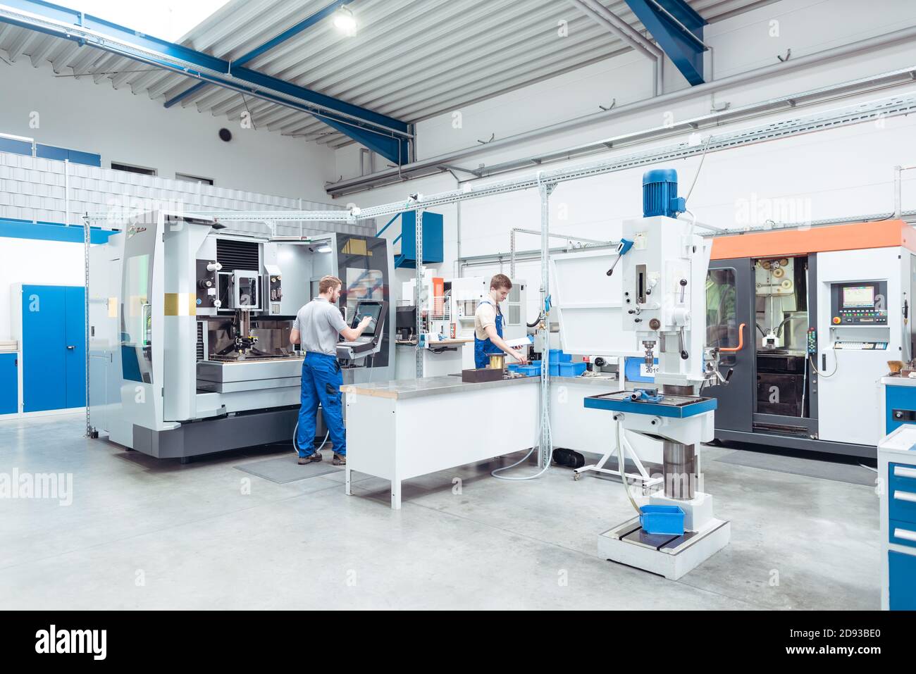 Workers producing industrial appliances in modern factory Stock Photo ...