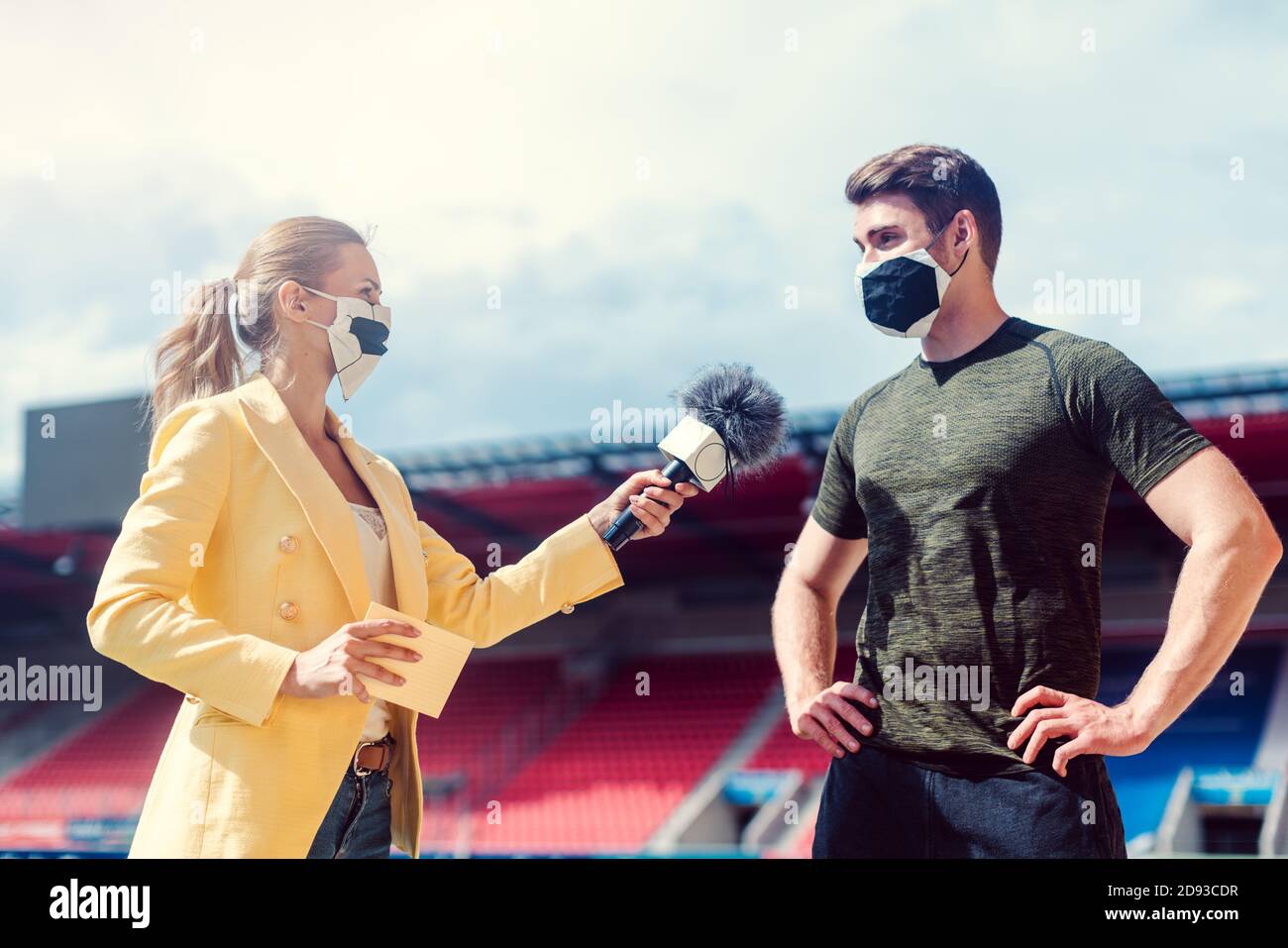 Reporter doing interview with football player during covid-19 Stock ...
