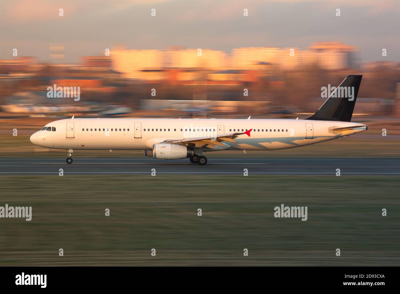 Passenger airplane taxing on runway for take off at sunset, side view ...