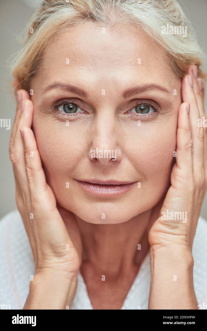 Portrait of beautiful middle aged caucasian woman looking at camera ...