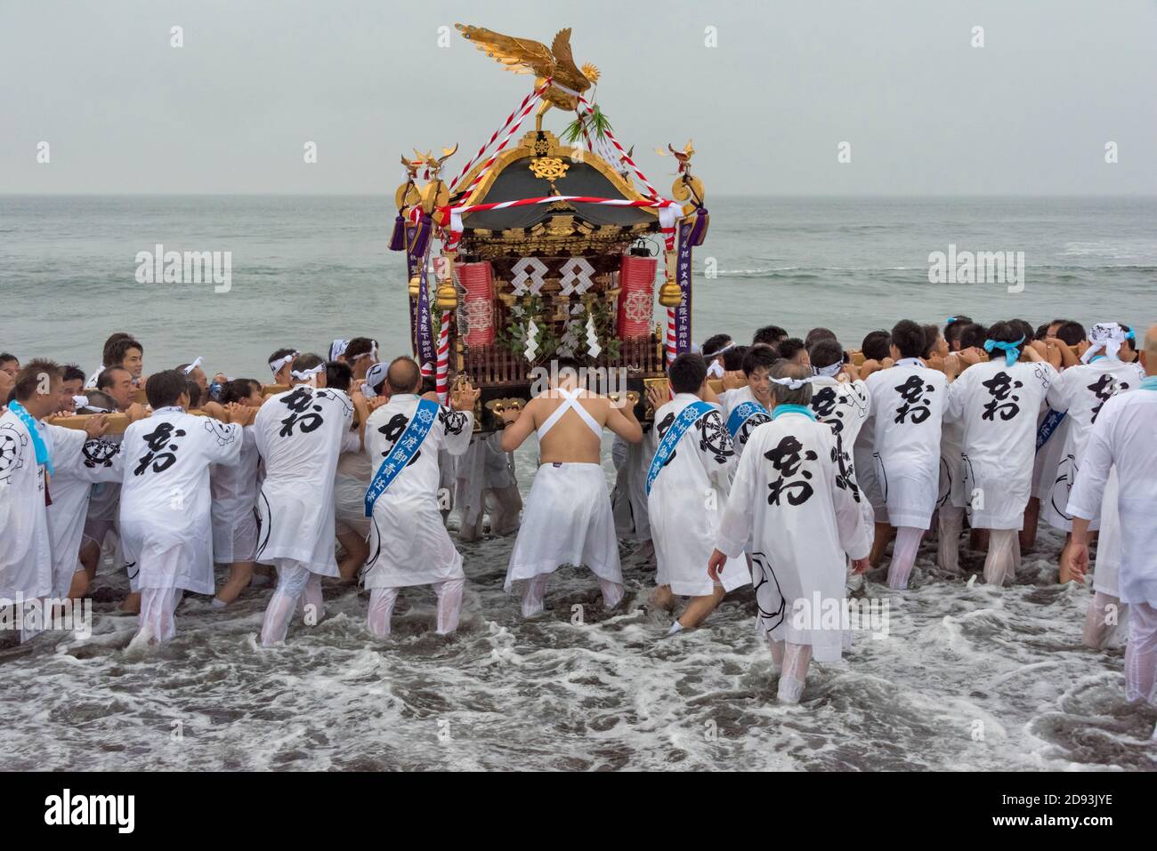 Parade carrying portable Mikoshi shrines to the sea celebrating Hamaori ...