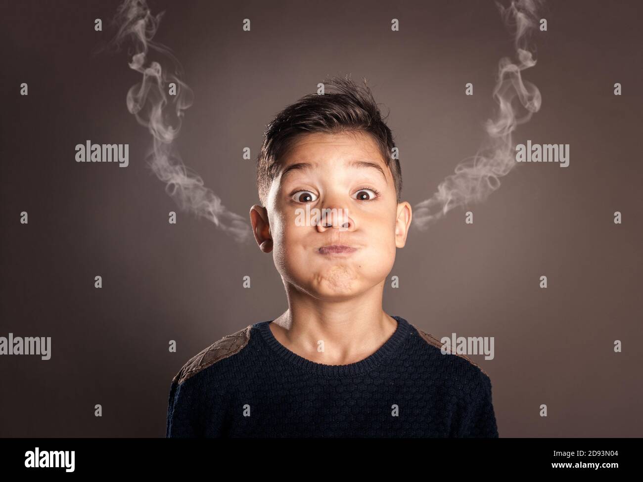kid with smoke on his ears on a gray background Stock Photo - Alamy