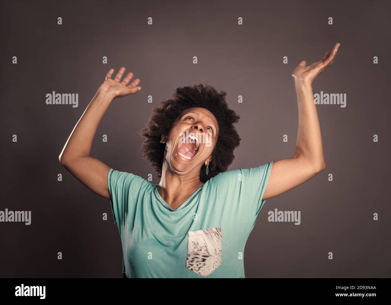 black woman screaming on a gray background Stock Photo - Alamy