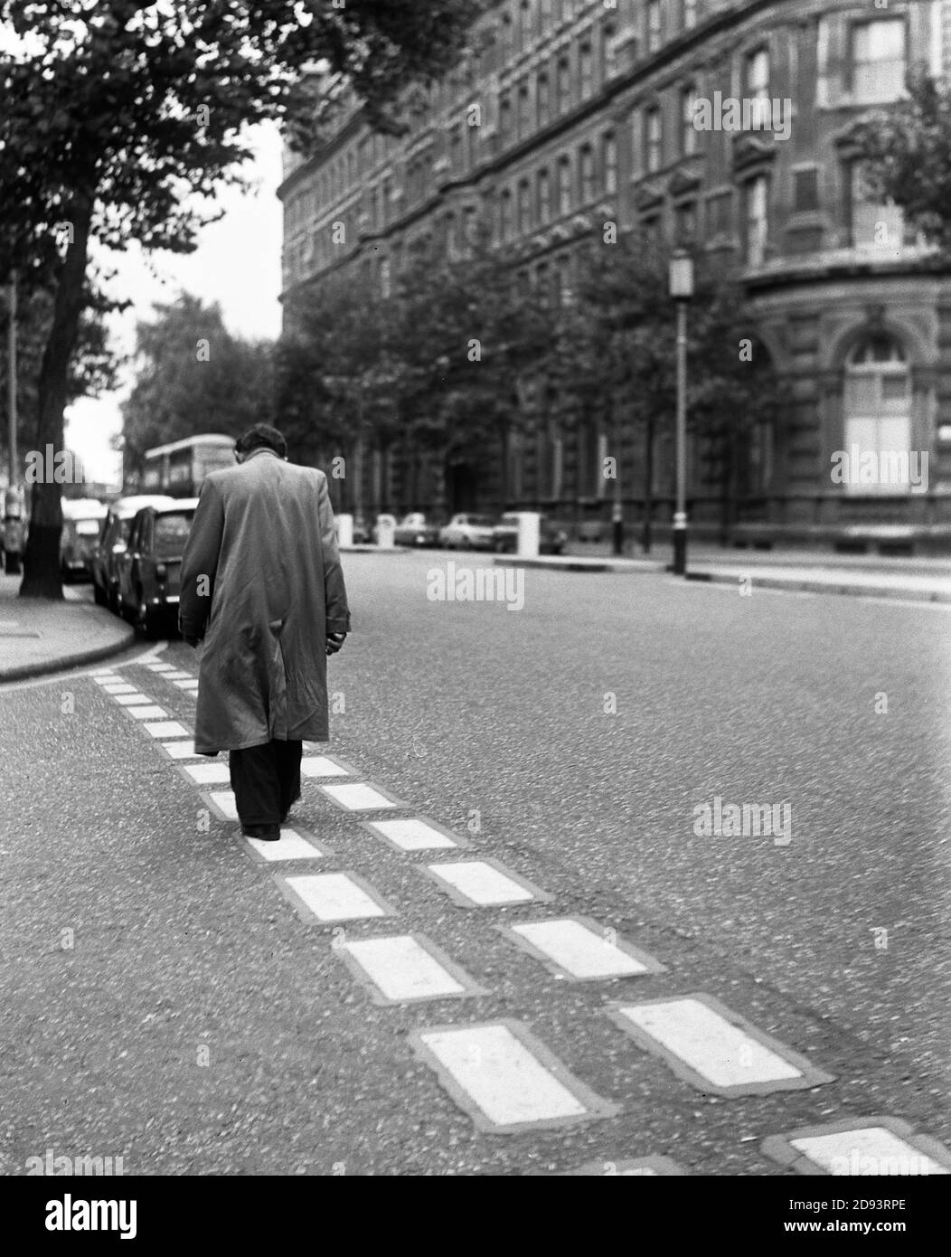 A man crosses the street, London, England, 1971 Stock Photo - Alamy