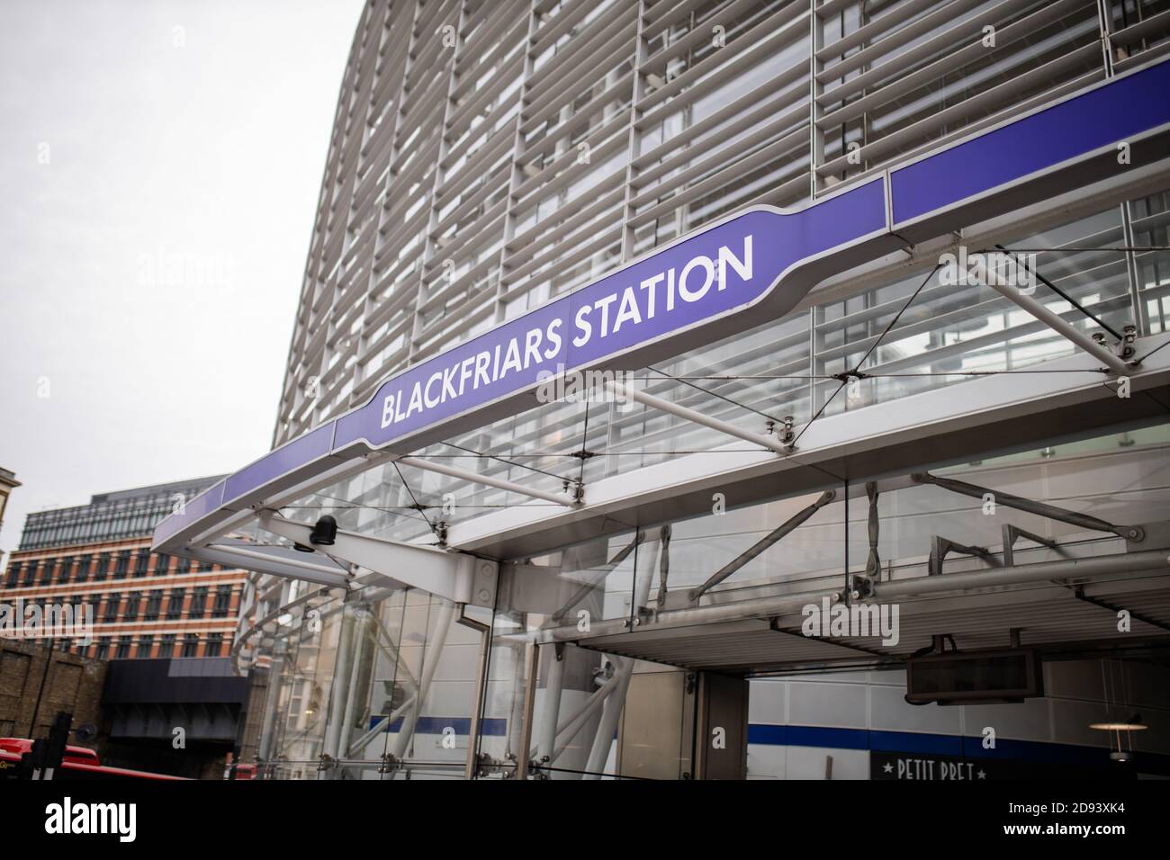 The entrance of the Blackfriars Station on a building covered with gray ...
