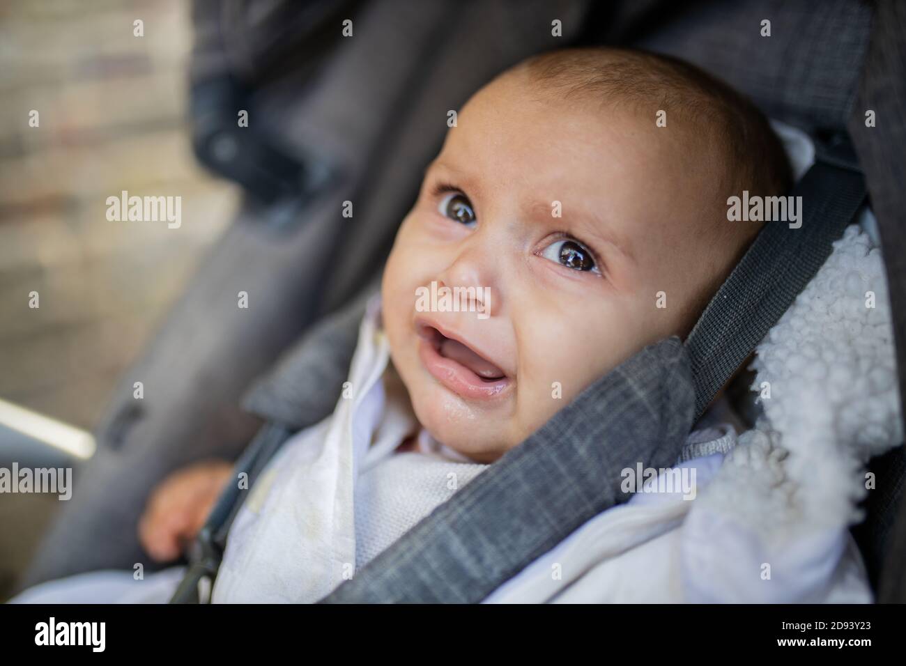 Crying baby in gray stroller hi-res stock photography and images - Alamy