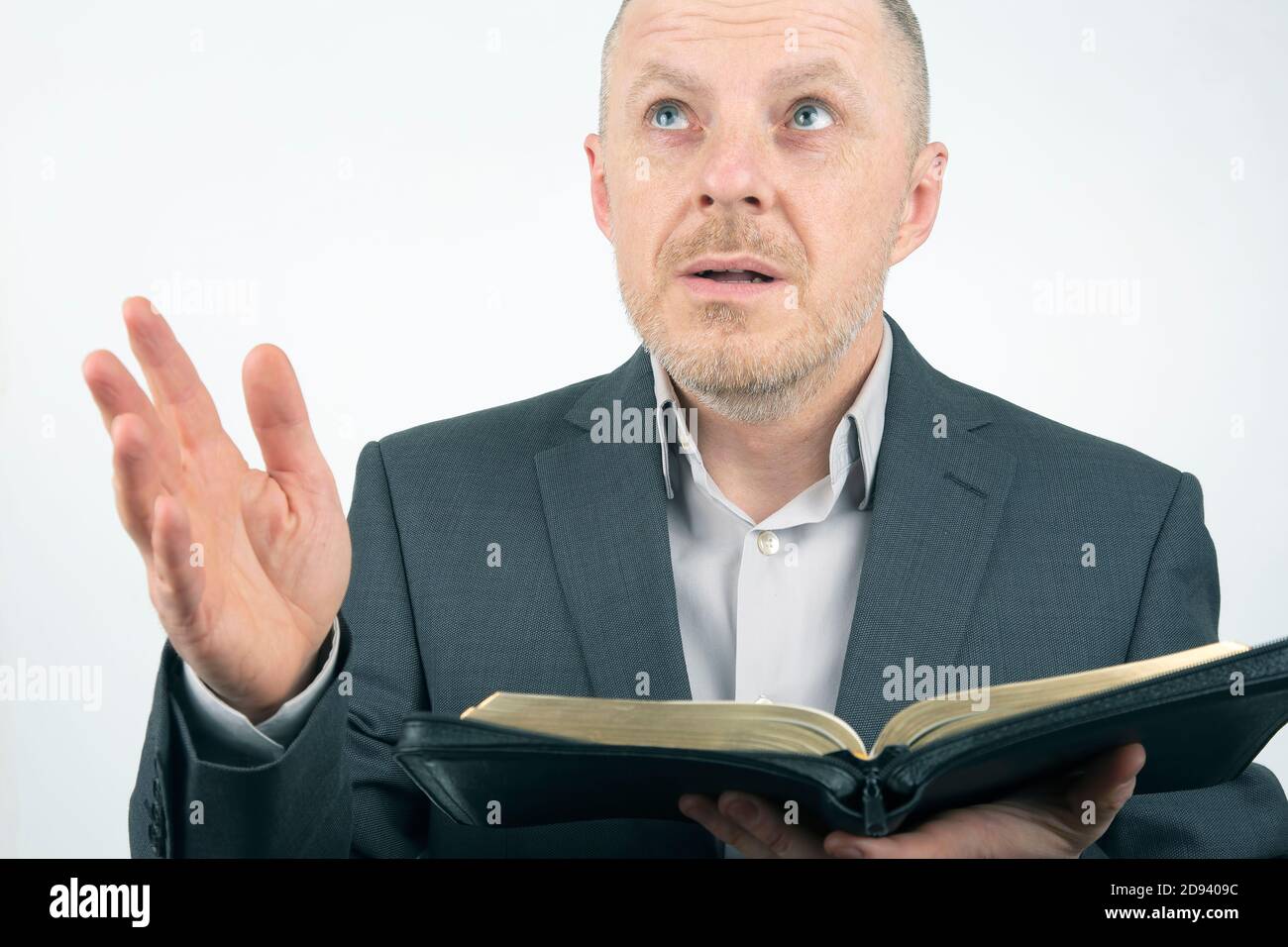 Man in suit holding bible hi-res stock photography and images - Alamy
