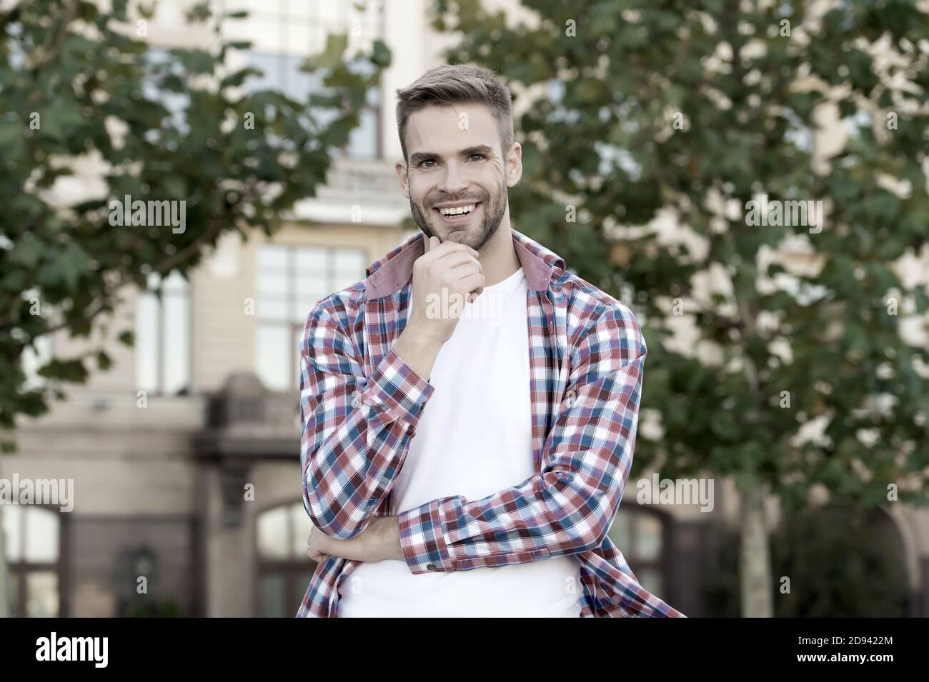 Cool about being scruffy. Unshaven guy smile urban outdoor. Happy man ...