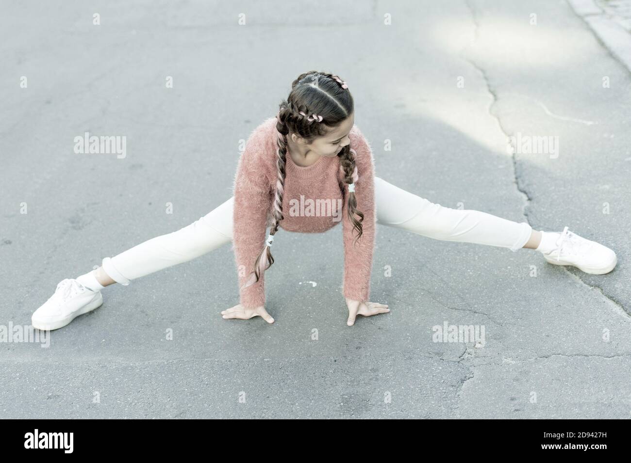 Stretching exercises to prevent sports injuries. Small gymnast outdoor ...