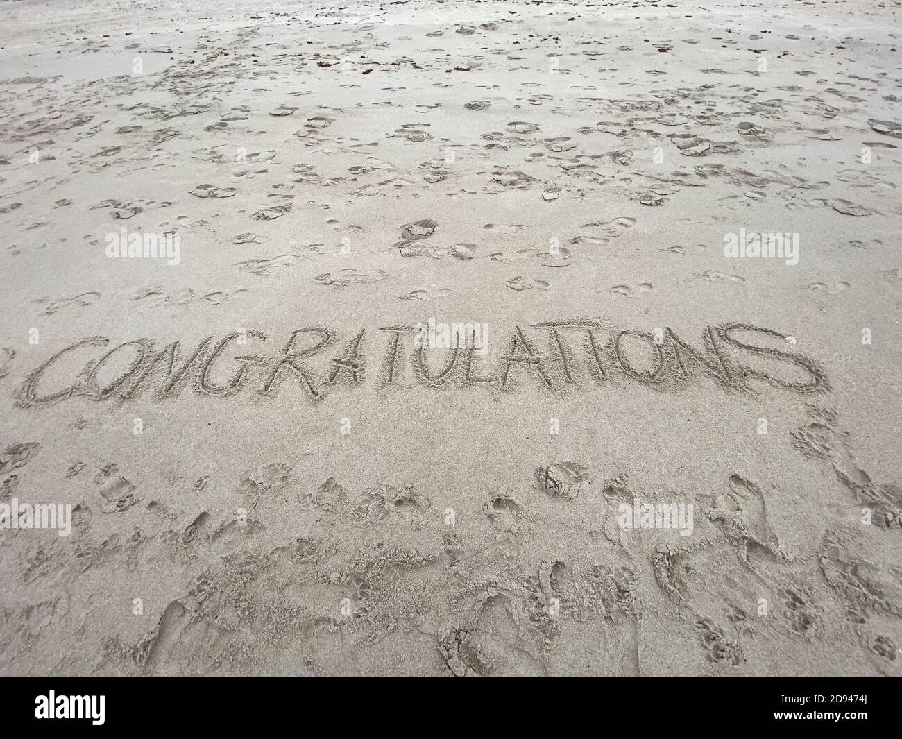 Congratulations written in the sand on a beach Stock Photo - Alamy