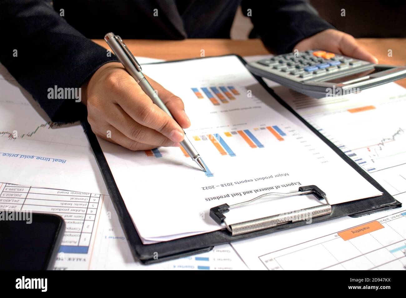 Businessmen are reviewing reports, financial documents for financial ...