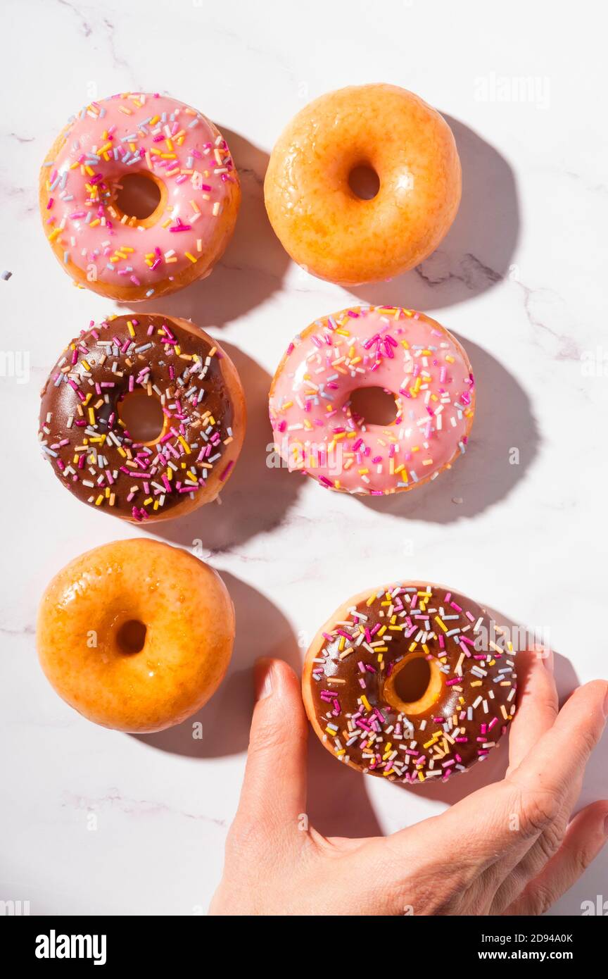 Doughnuts with different glaze, traditional sweet pastries topped with ...