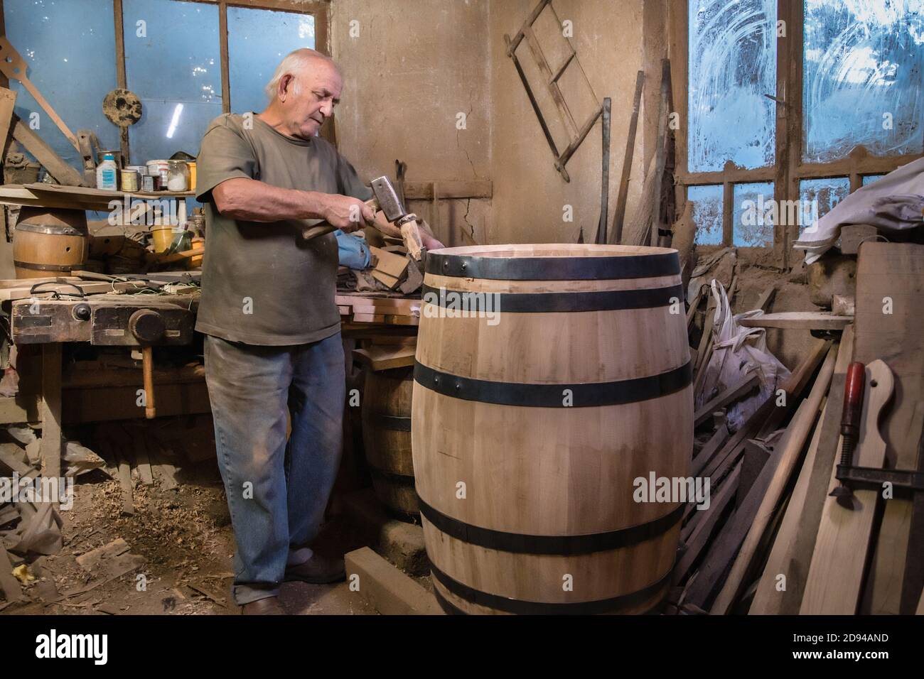 Production of wooden wine barrels. The master makes a wooden jars and ...