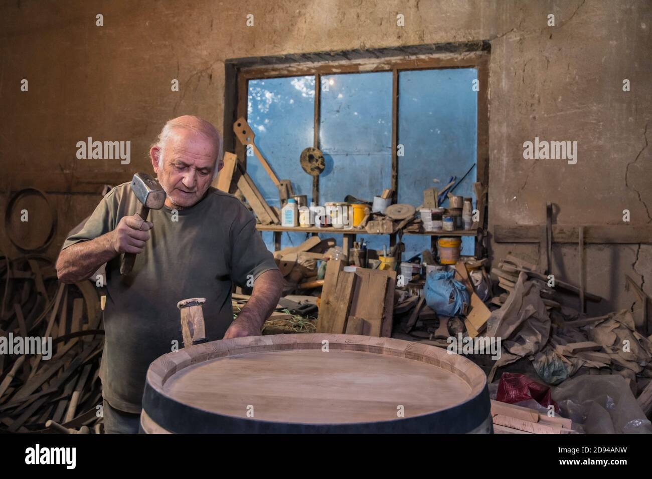 Production of wooden wine barrels. The master makes a wooden jars and ...