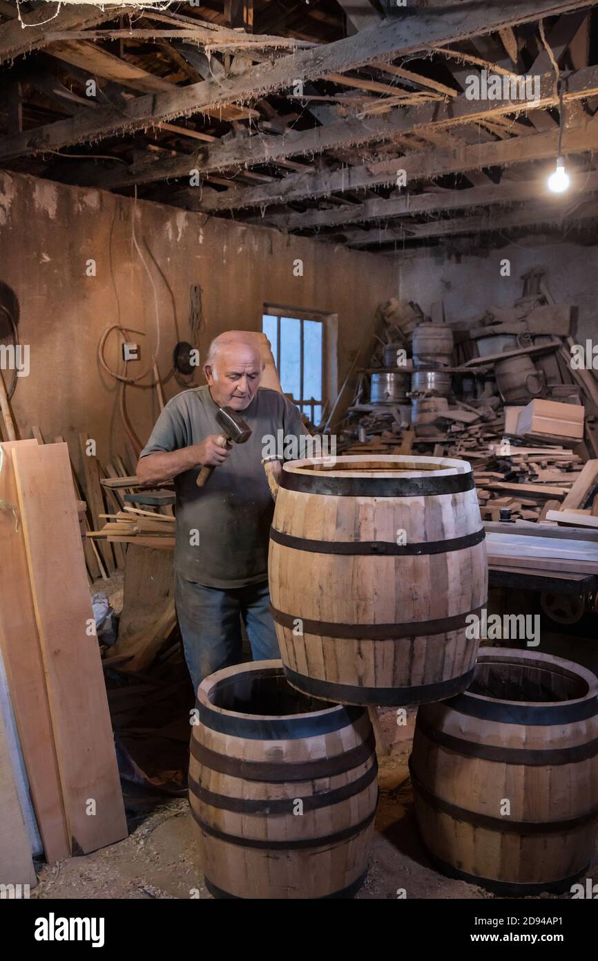 Production of wooden wine barrels. The master makes a wooden jars and ...
