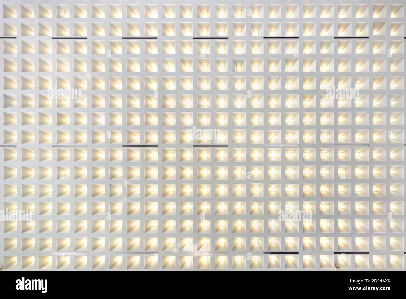 rhythmic texture on suspended ceiling with rows of halogen spots lamps ...