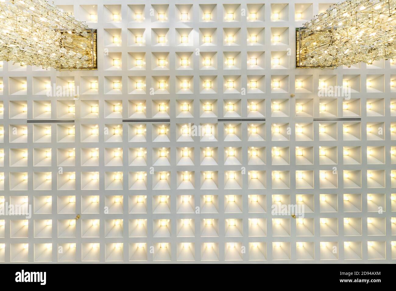 rhythmic texture on suspended ceiling with rows of halogen spots lamps ...