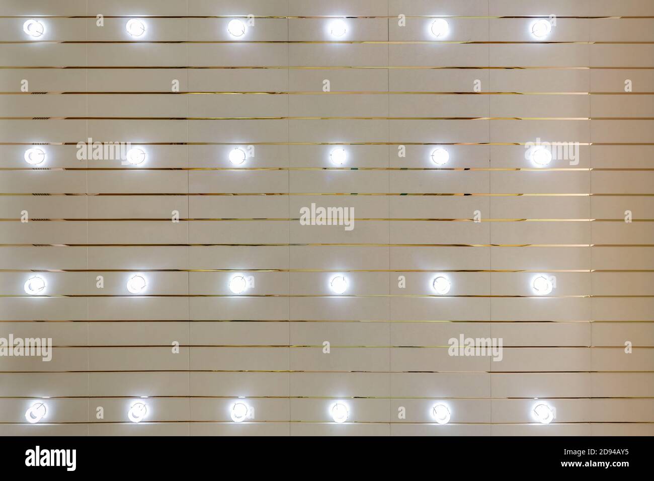 rhythmic texture on suspended ceiling with rows of halogen spots lamps ...