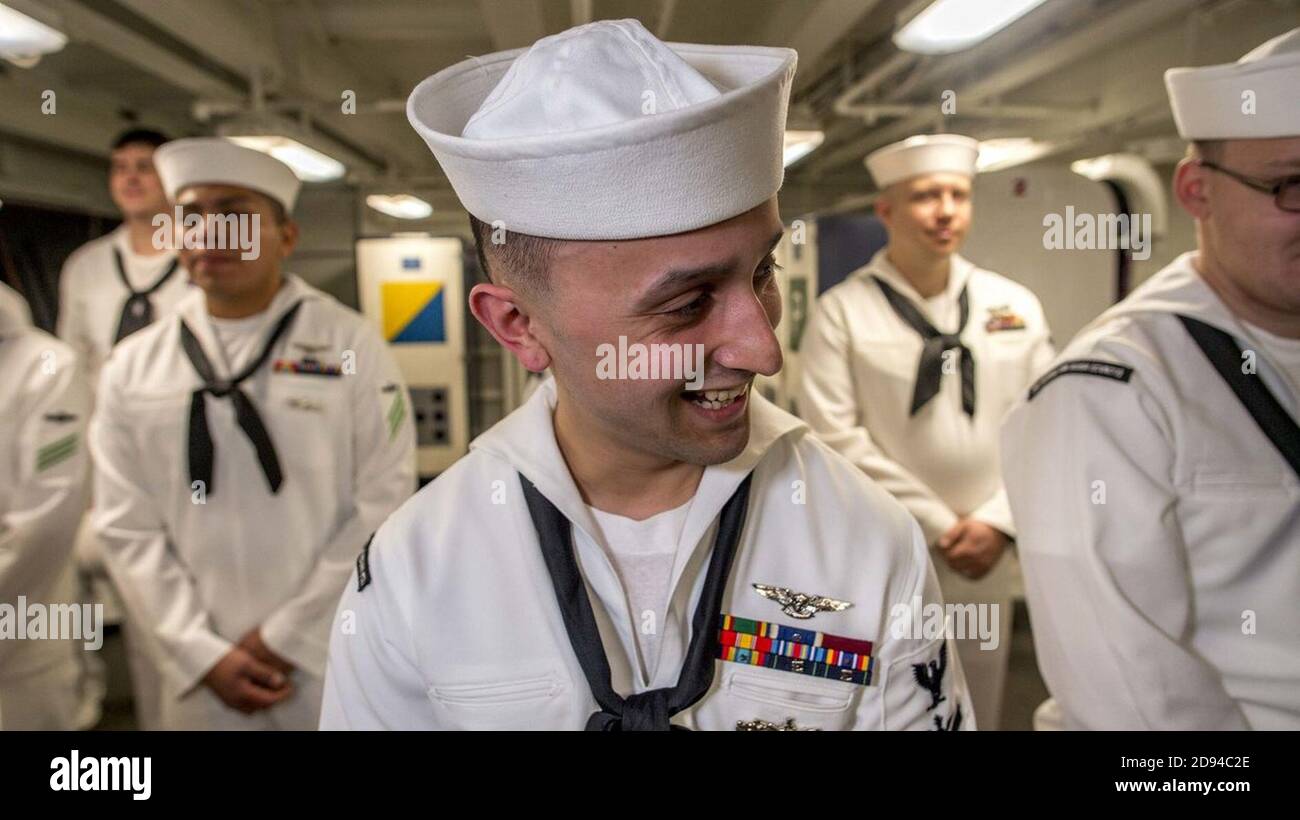 Julio Pino laughs after a service dress white uniform inspection aboard ...