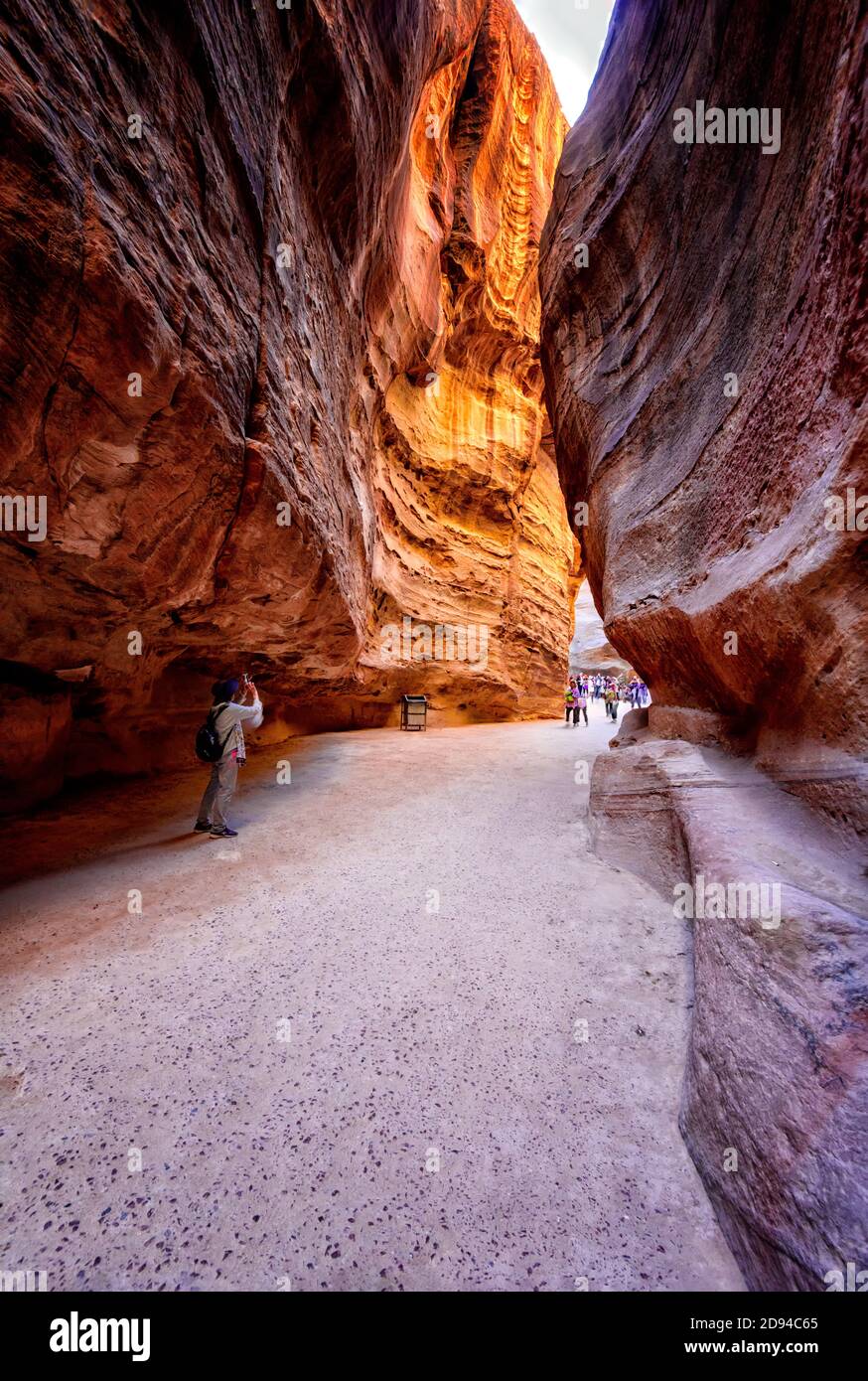 Tourists walking through Al Siq Canyon between the entrance to the ...