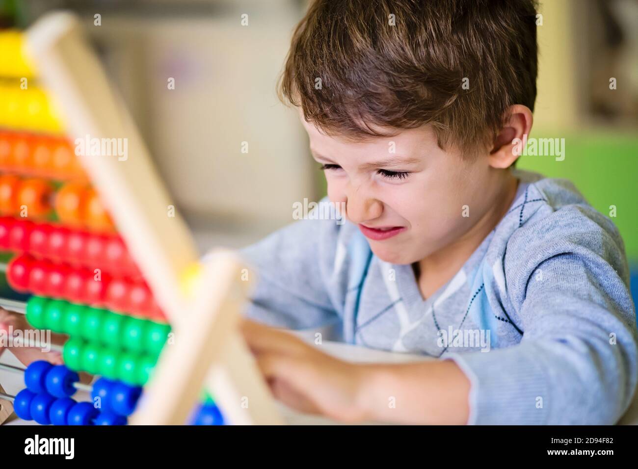 Cute Caucasian baby boy feeling bored and frustrated while playing with ...