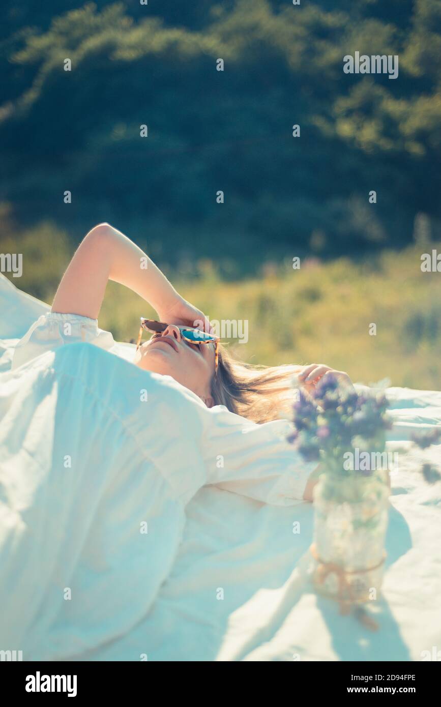 Young woman laying in her back in nature relaxation concept Stock Photo ...