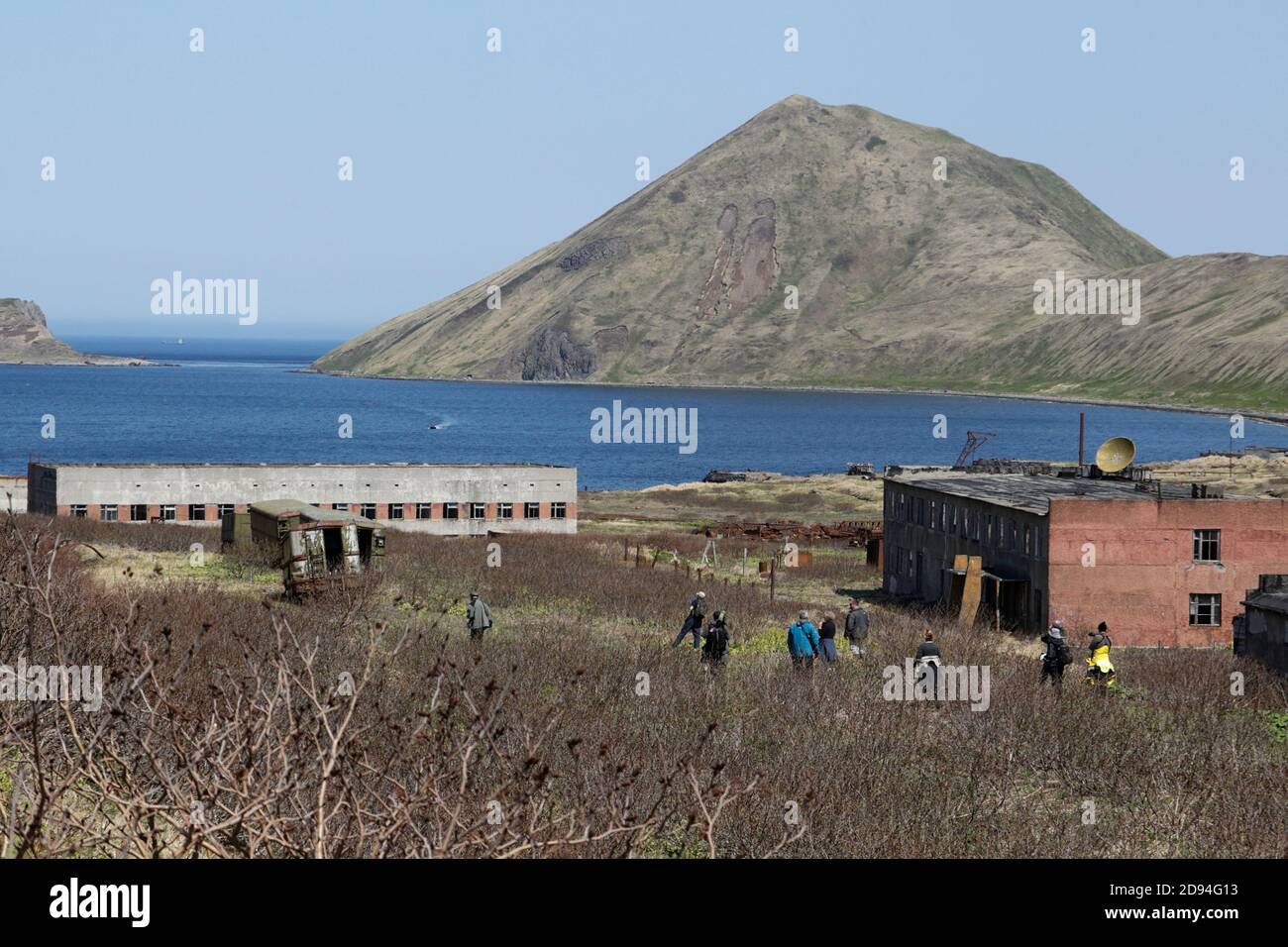 Tourists wandering around abandoned Russian Submarine base, Simushir ...
