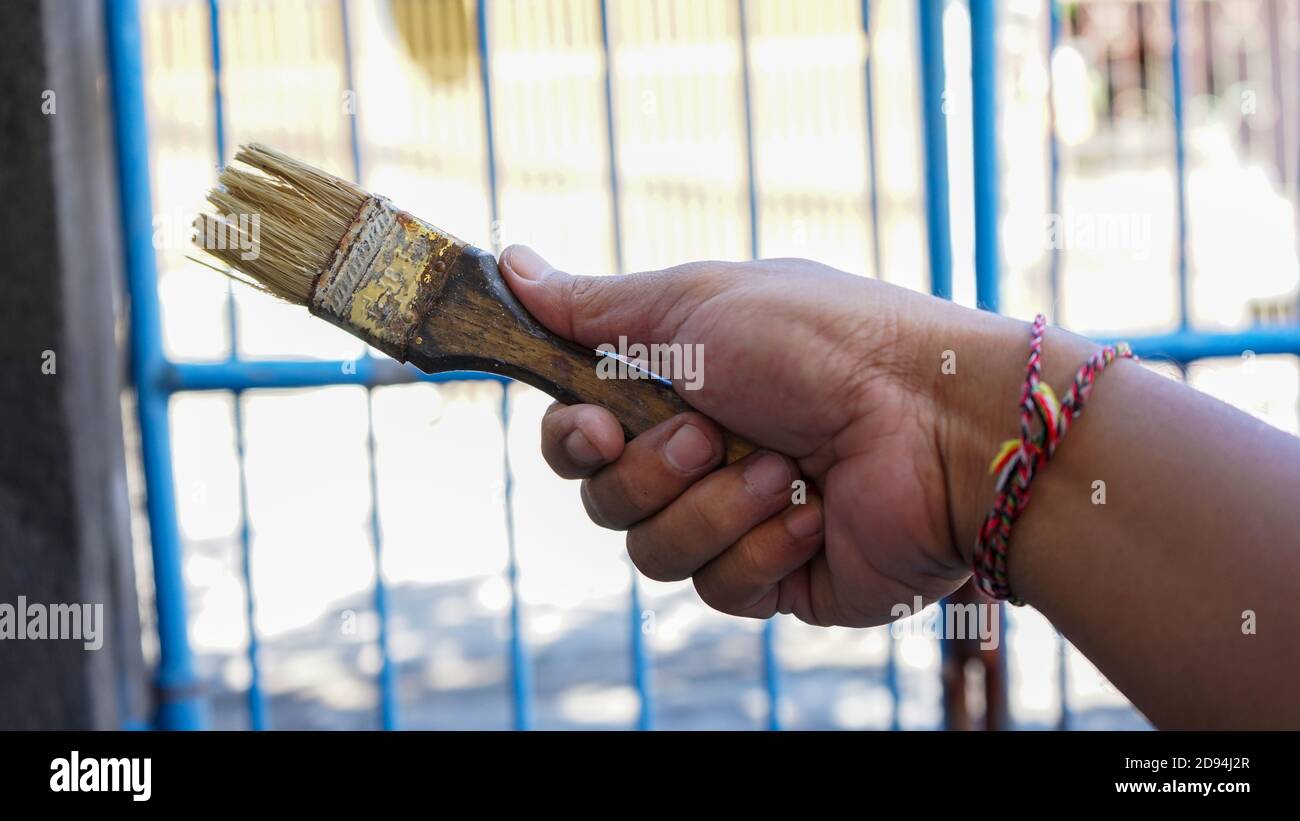 Close up hand holding artisan tools Stock Photo - Alamy