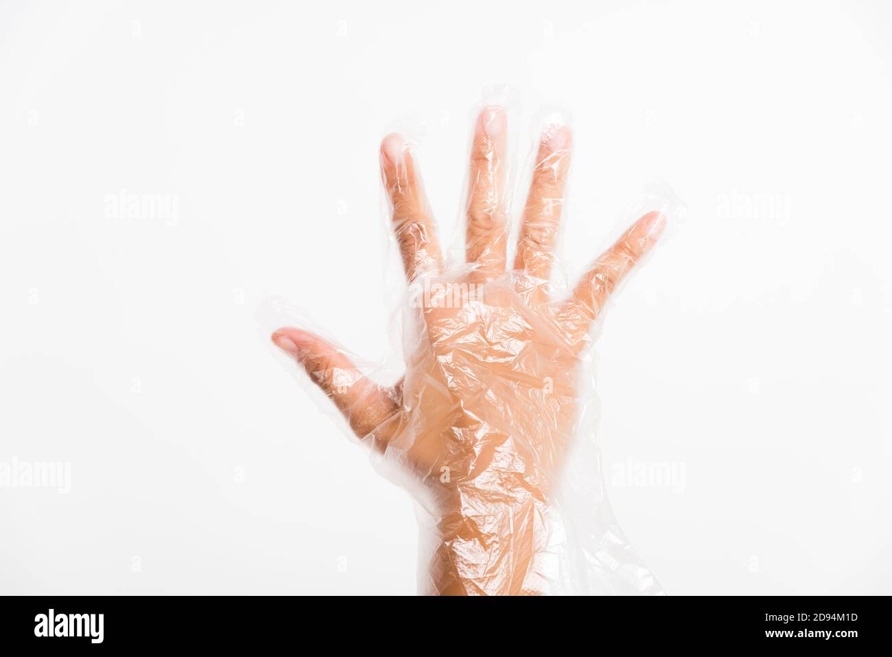 Woman hand wearing single use protect disposable transparent plastic ...