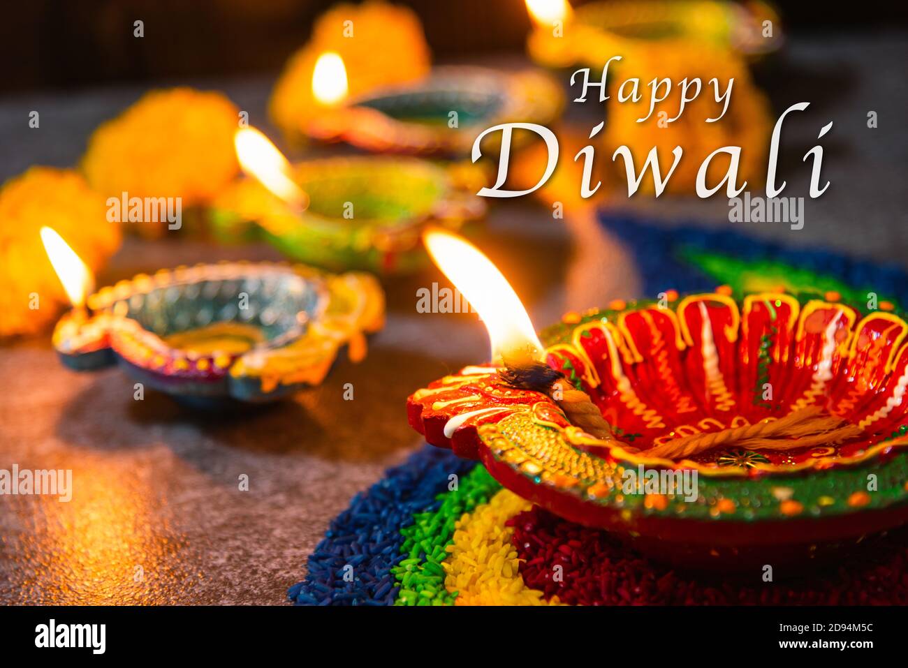 Close up clay lit light a fire already on Diya or oil lamp with flowers ...