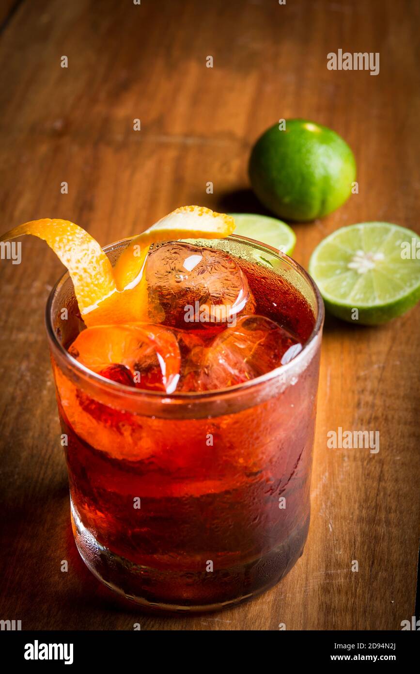 a red cocktail sour drink with lime Stock Photo - Alamy