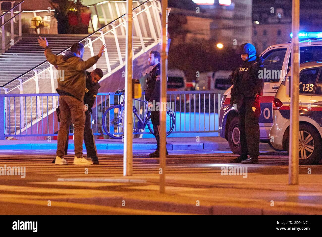 Vienna, Austria. 2nd Nov, 2020. Police officers check a man on a street ...