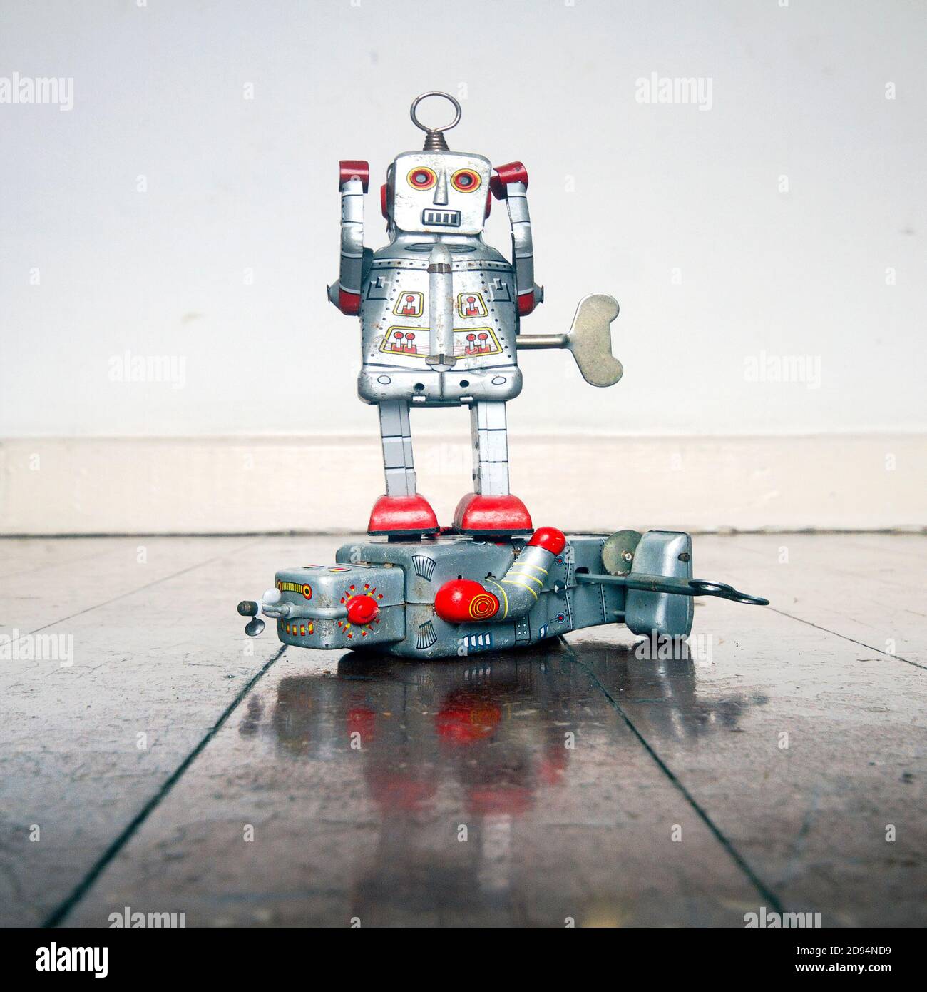 retro silver bot stands on top another silver bot Stock Photo - Alamy