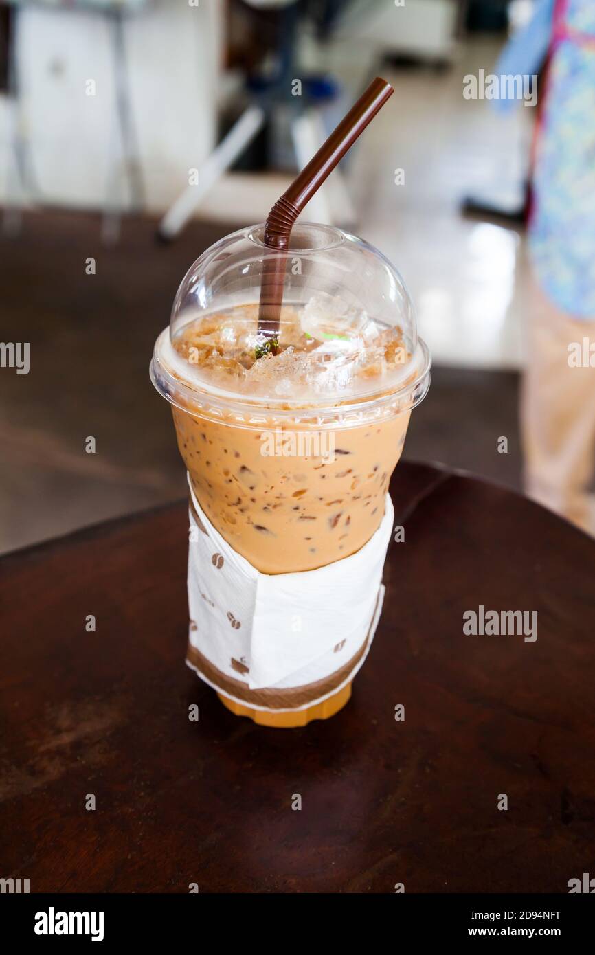 Iced coffee with on the wood table background Stock Photo - Alamy