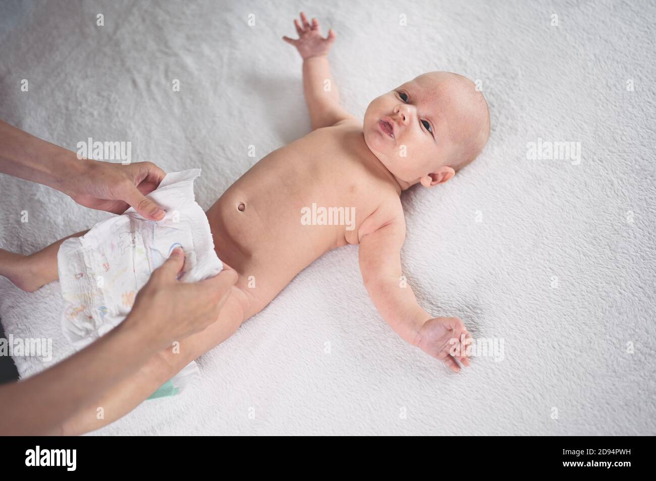 Mom is changing diaper cute emotional funny newborn little baby boy ...