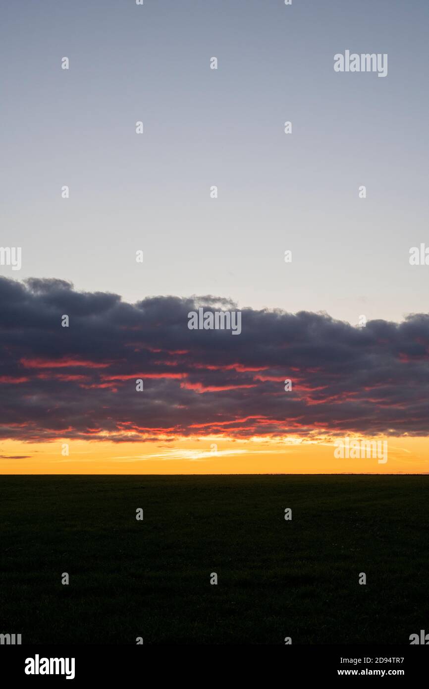Band of rain clouds at sunset over the cotswold countryside. Cotswolds ...