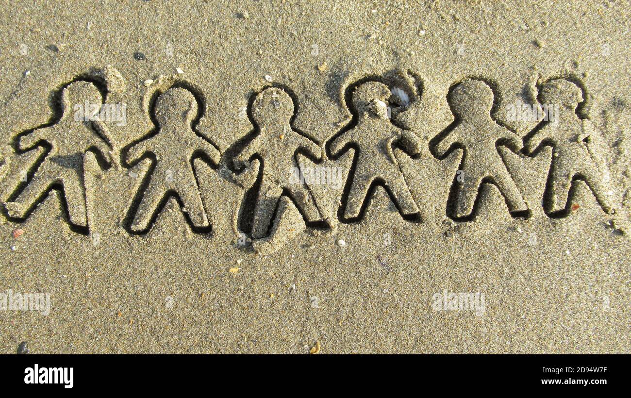 Human shapes carved on to the sea sand in a public beach Stock Photo ...