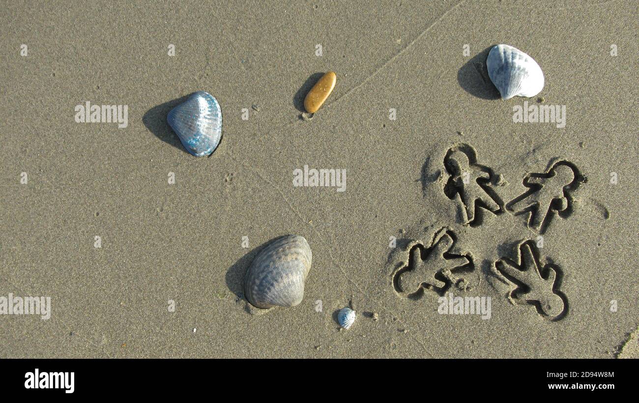 Human shapes carved on to the sea sand in a public beach Stock Photo ...