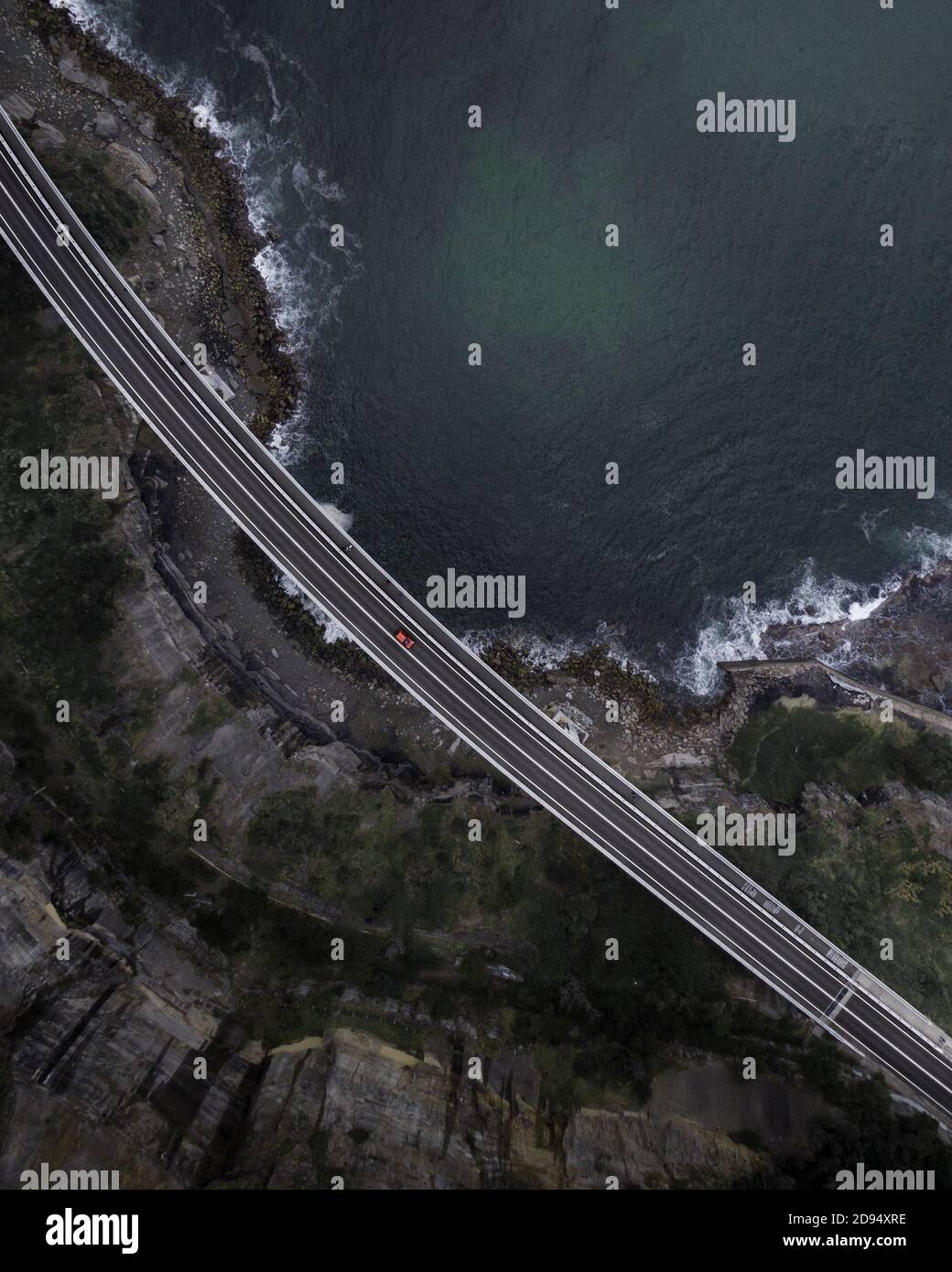 Aerial top view of a straight paved highway road with a single car ...