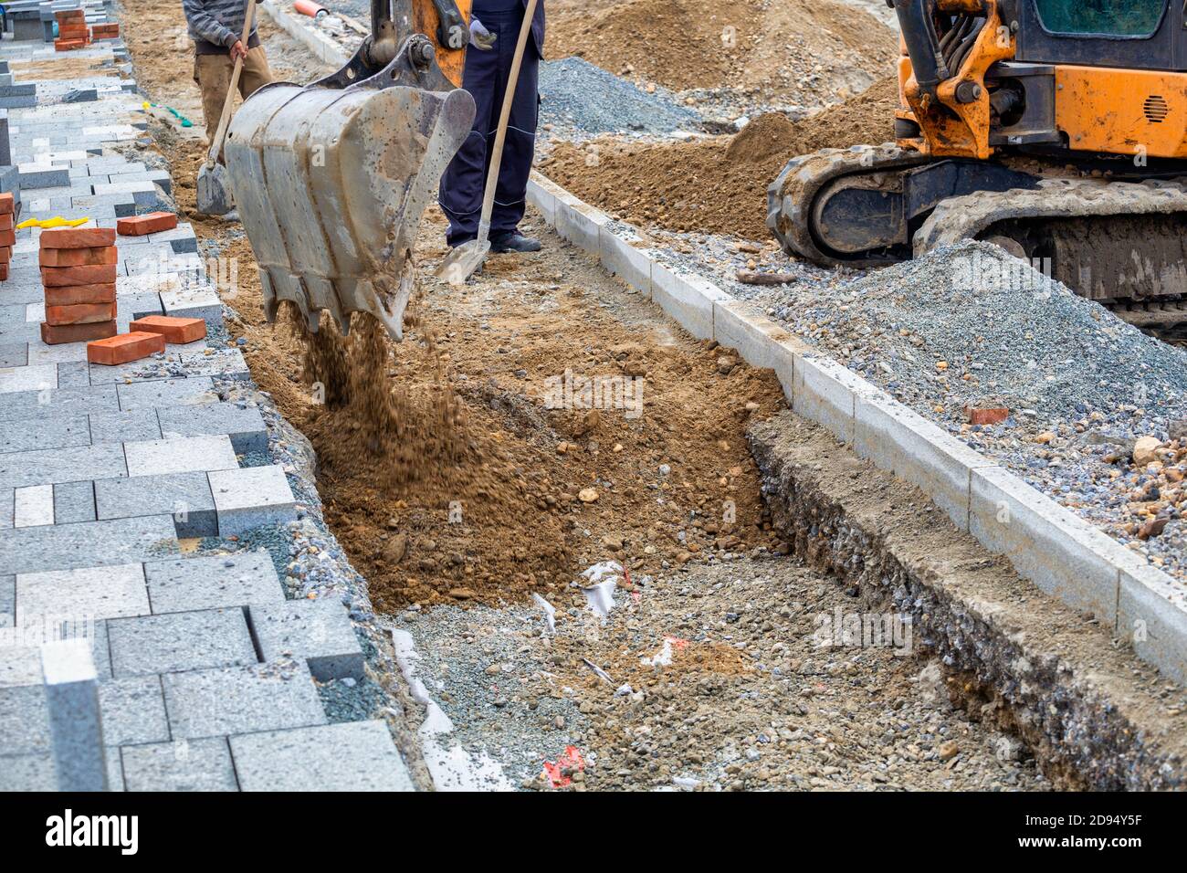 Backfilling power cables trenches during a sidewalks or patio ...
