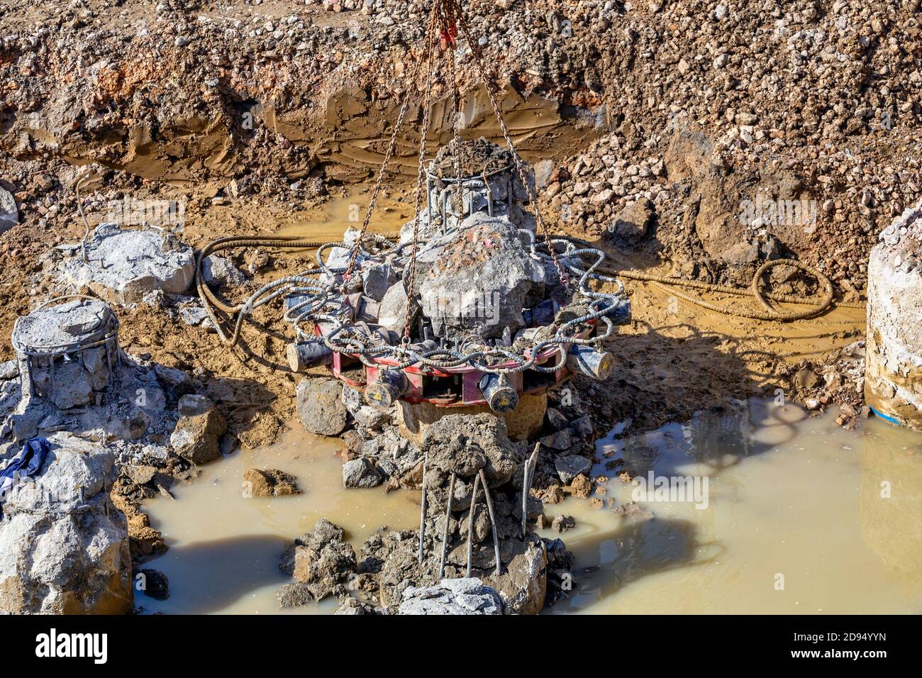 Hydraulic pile breaker, unit drops over the top of the pile then the ...