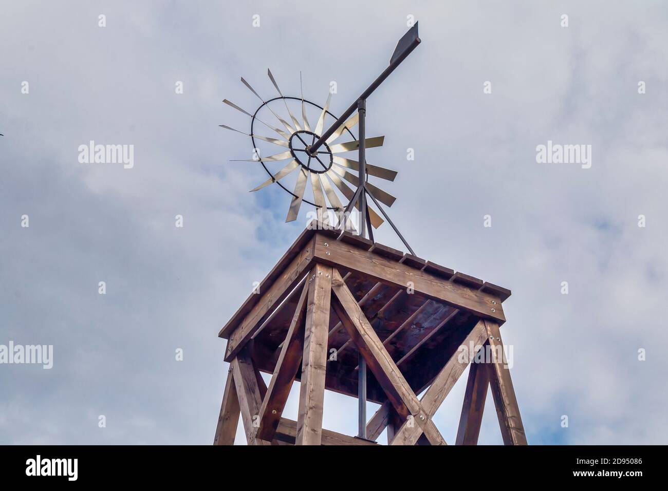 Old farm windmill with metal blades and tail vane Stock Photo - Alamy