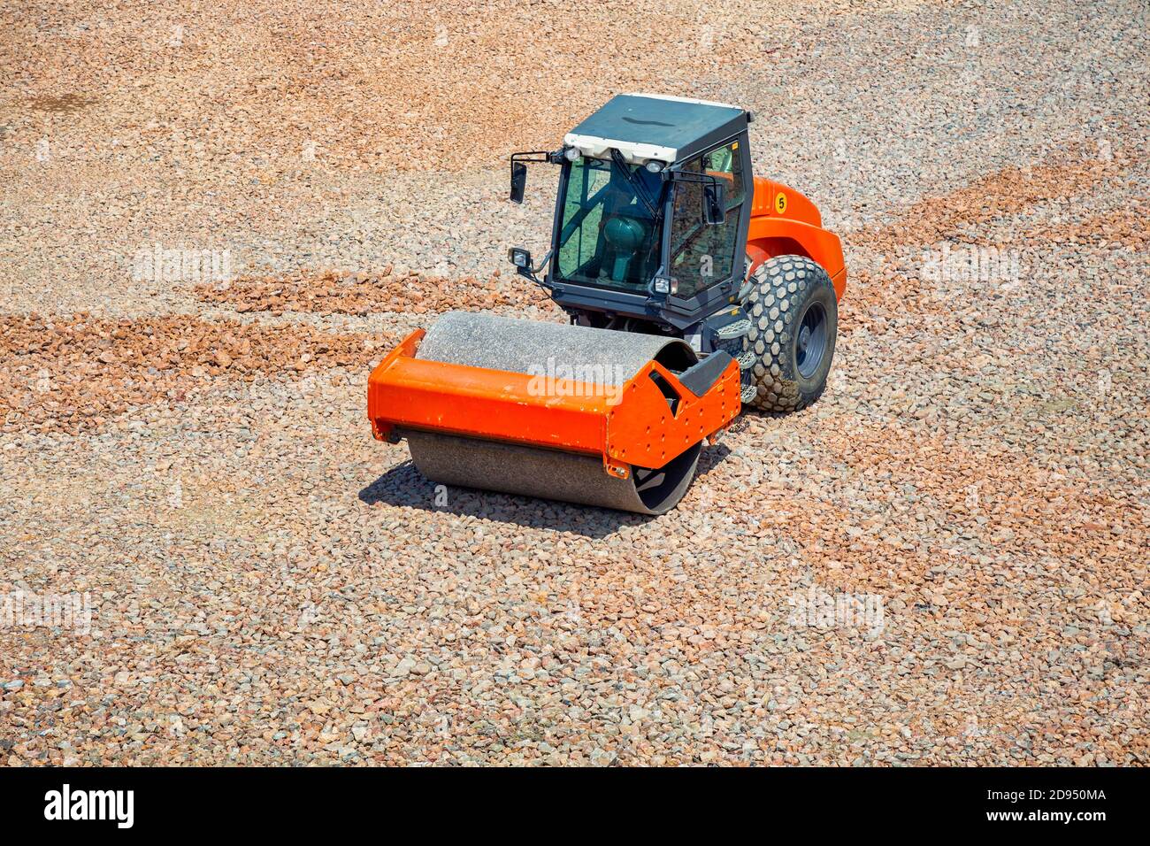 Roller on a construction site leveling the ground Stock Photo - Alamy