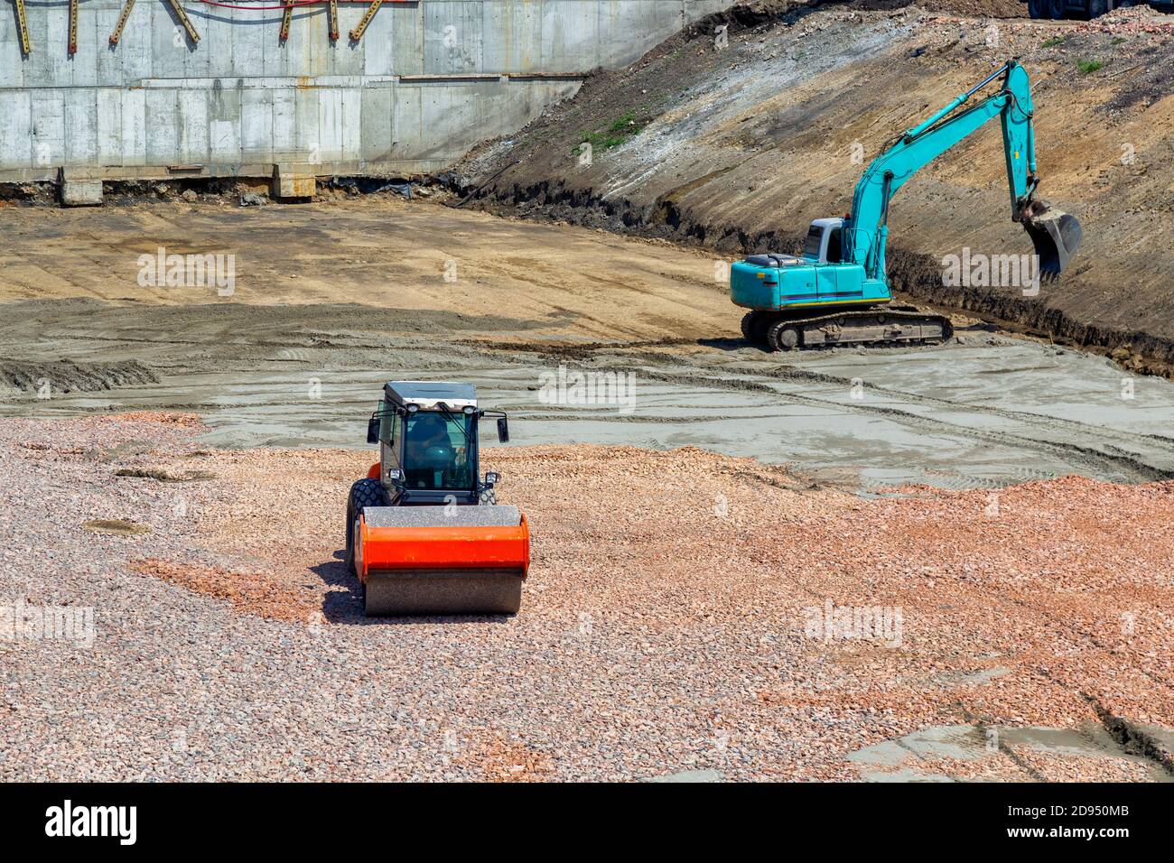 Roller leveling the ground of the foundation for new building ...