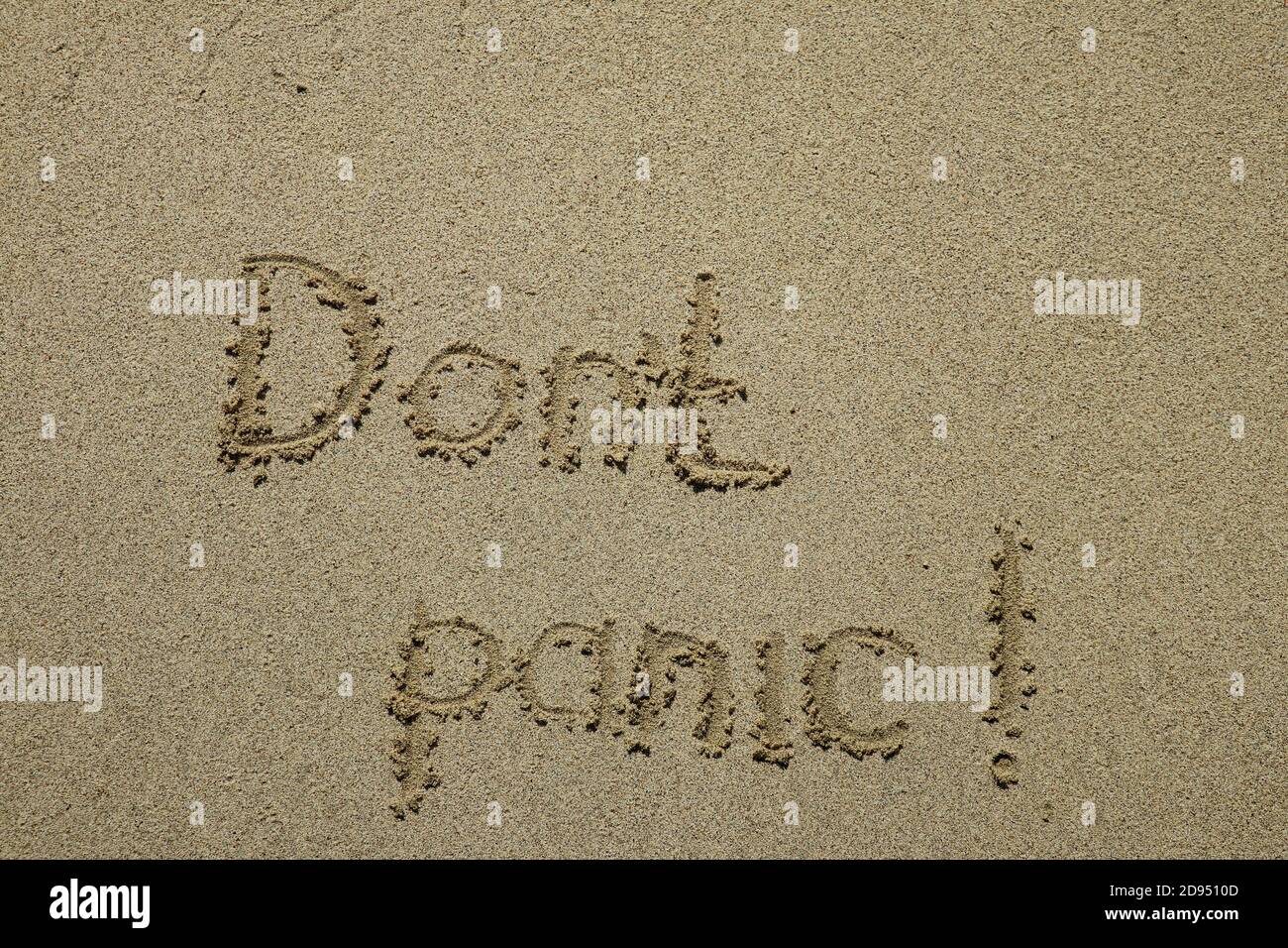 Dont panic concept written on the sand, stress Stock Photo - Alamy