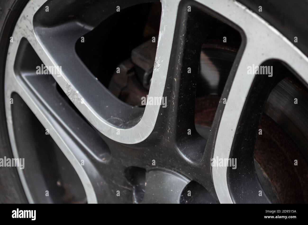 Wheel rim with scratches and dirt. Scratches and abrasions on the cast ...