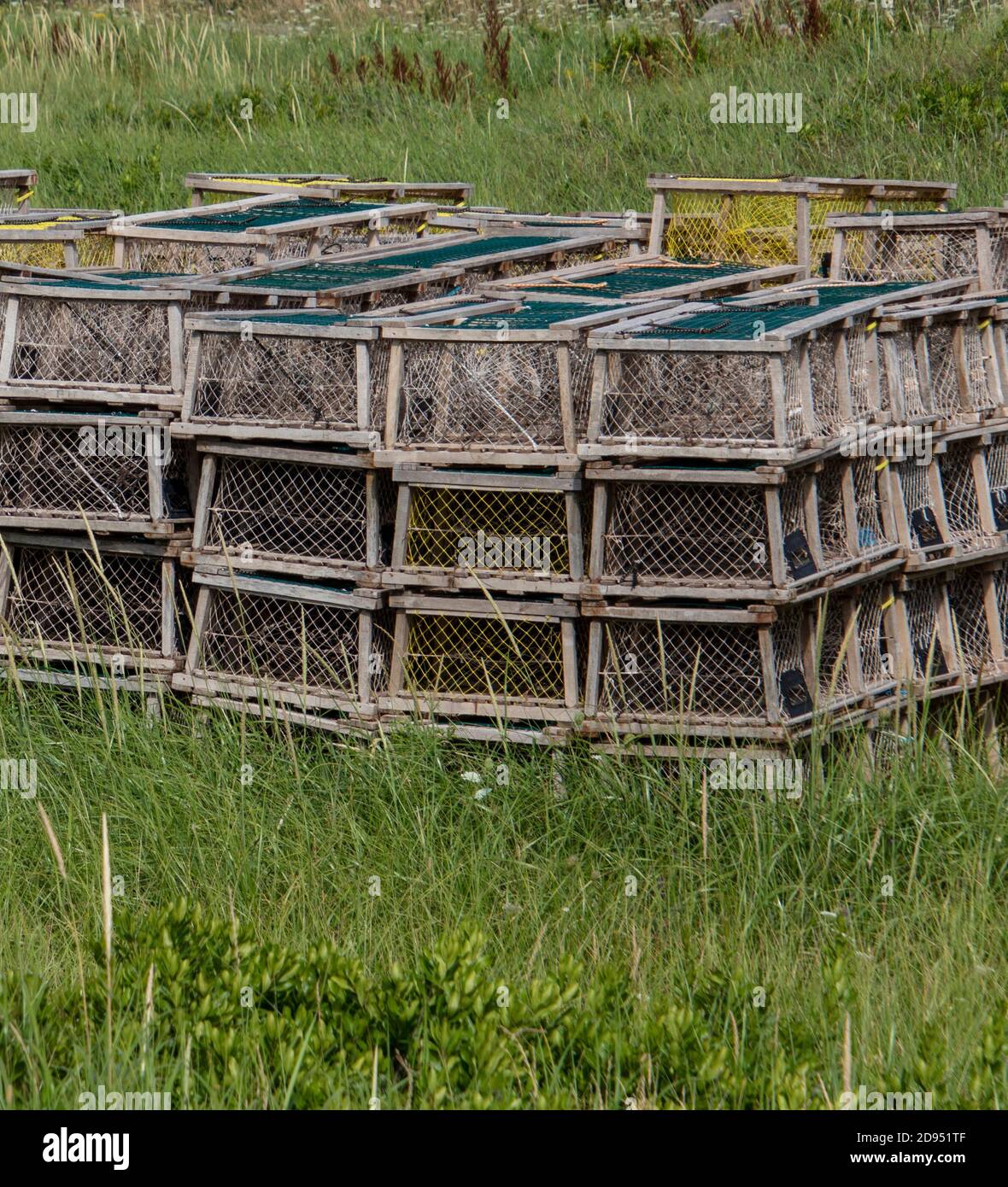 A large stack of lobster traps sitting in a field Stock Photo - Alamy