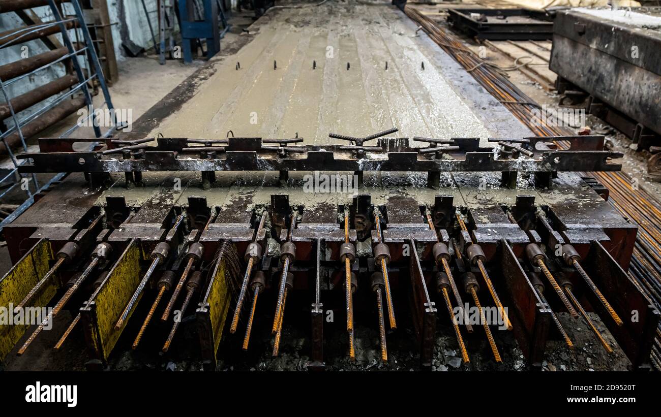 The production process is the creation of reinforced concrete pillars ...